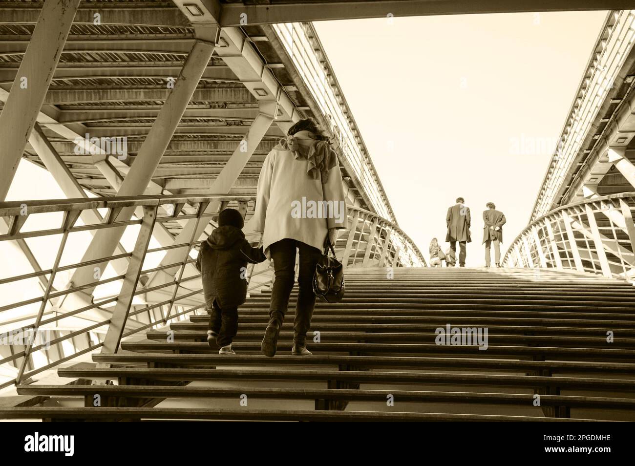 Mother and child (unidentified; back view) on Solferino bridge over ...