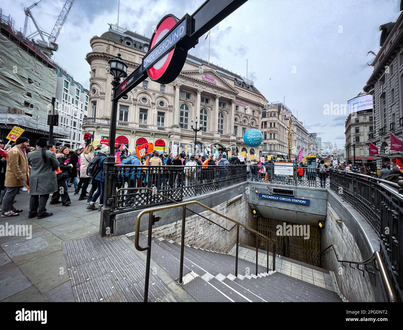 London, UK. 15th March, 2023. Protesters walk past closed tube station ...