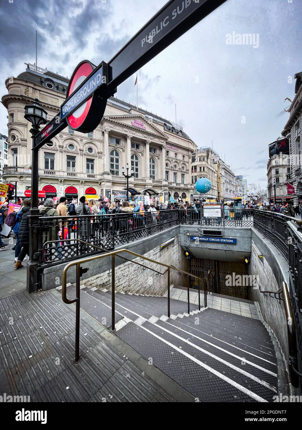 London, UK. 15th March, 2023. Protesters walk past closed tube station ...