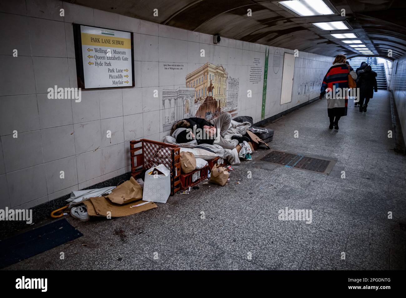 Homeless male sleeping in the underpass on Park Lane, Central London ...