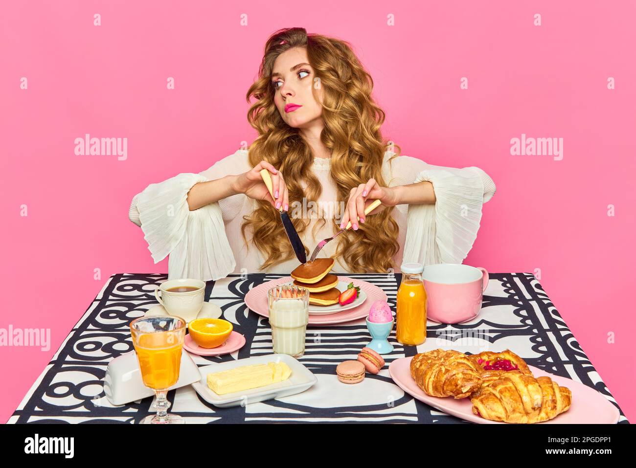 Good-looking redhead woman starting eat her sweet breakfast with calm face over pink background ...
