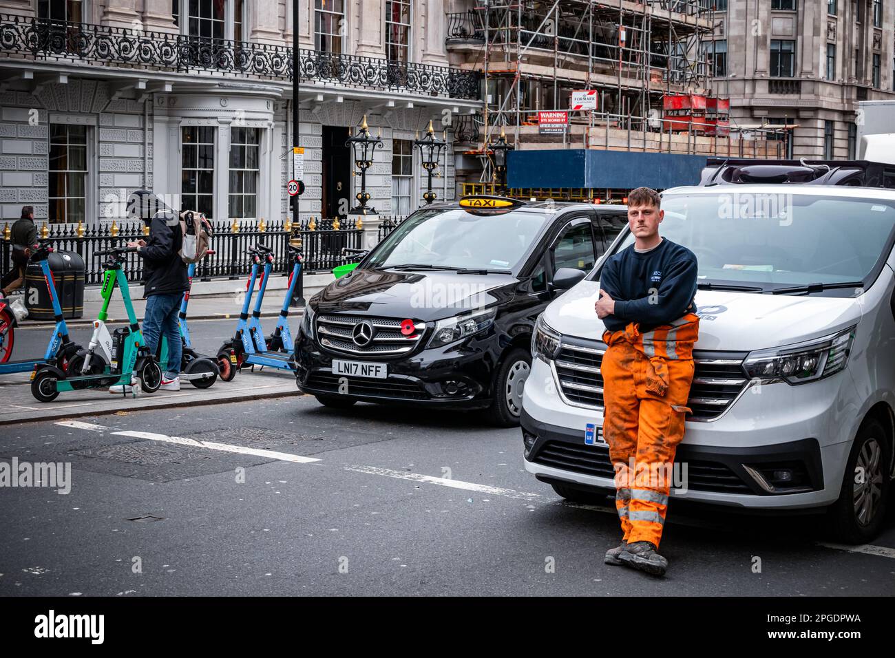 London, UK. 15th March, 2023. Workman stuck in traffic watch as demo ...