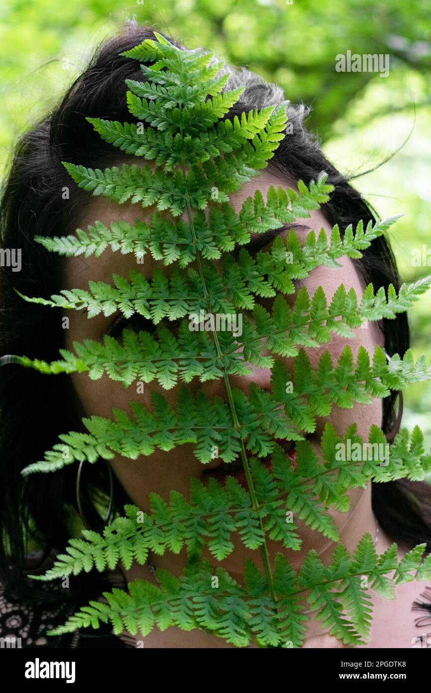 Mid adult woman holding leaf hi-res stock photography and images - Alamy