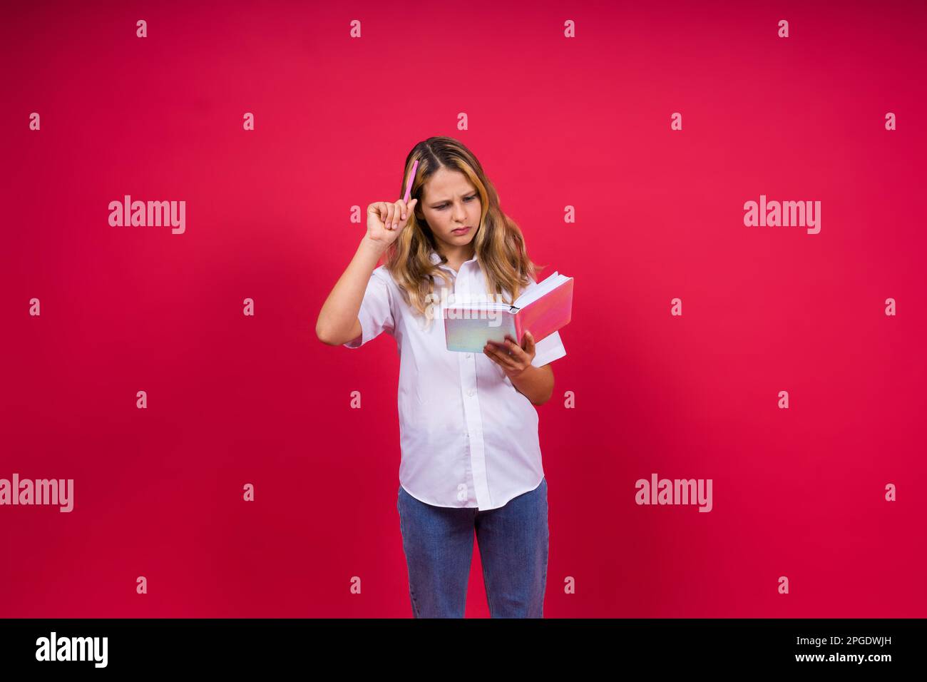 Child making notes. Kids dreams.Isolated on a red background. Education ...