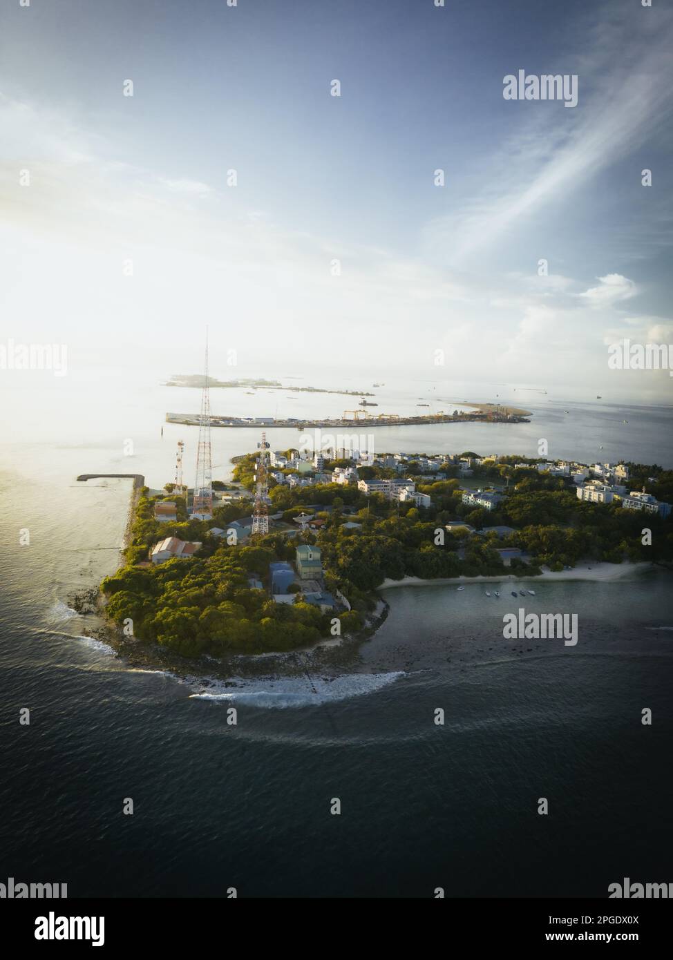 An aerial view of a picturesque small island surrounded by crystal blue ...