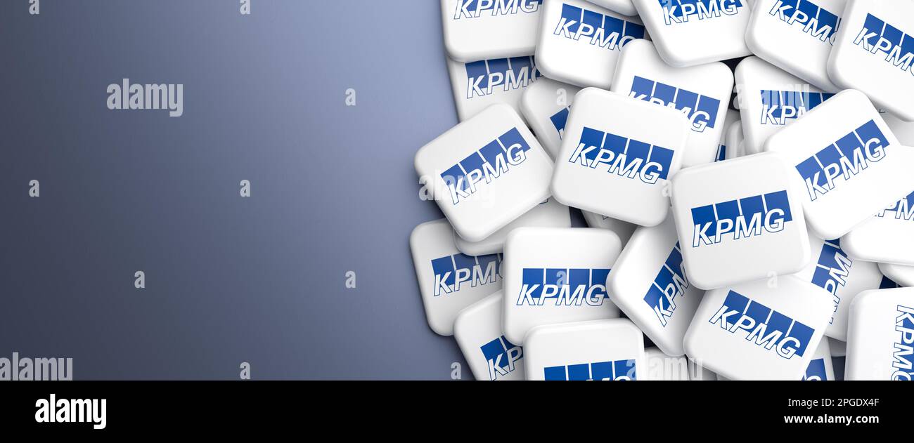 Logos of the Big Four accounting organization KPMG on a heap on a table ...