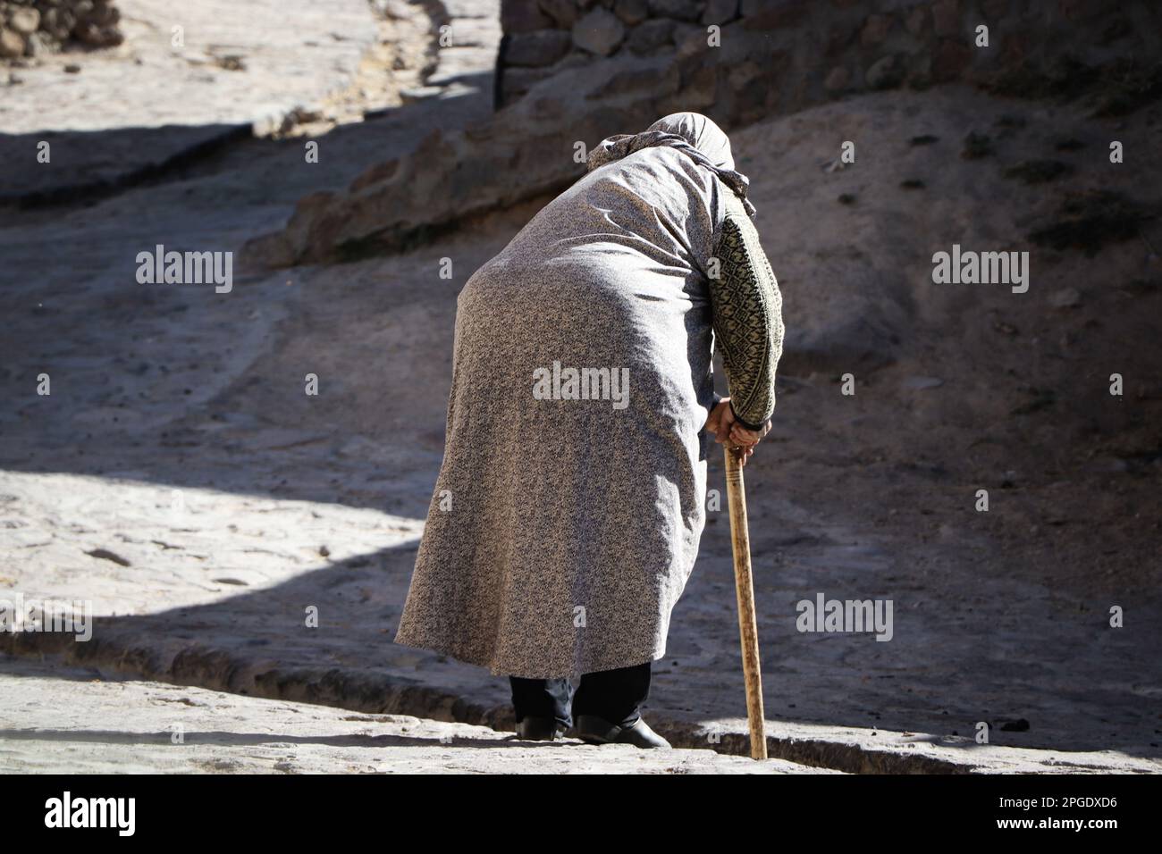 An old granny with a wooden walking stick walking in the street Stock ...