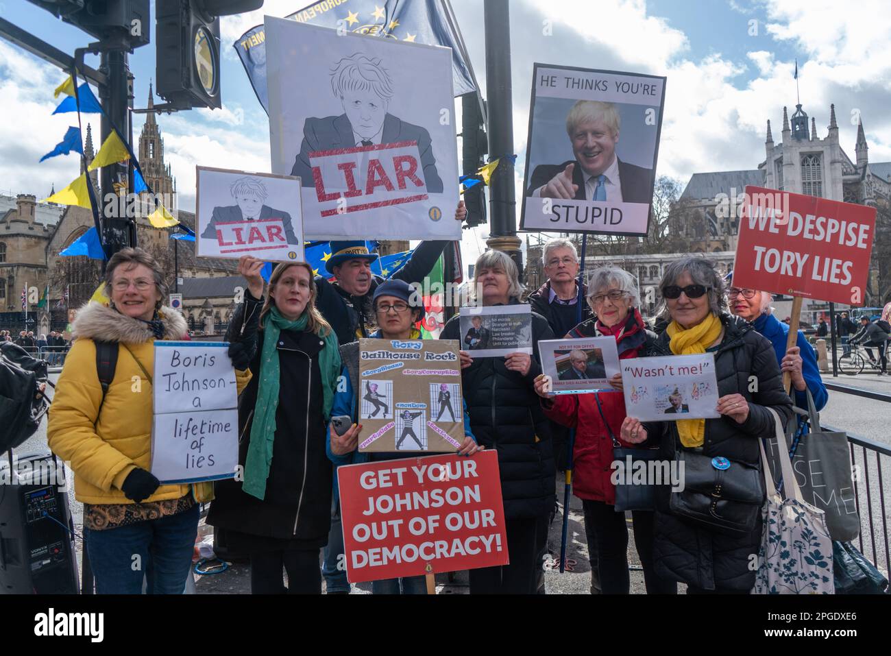 London, UK 22 March 2023. Protesters hold signs against former Prime ...