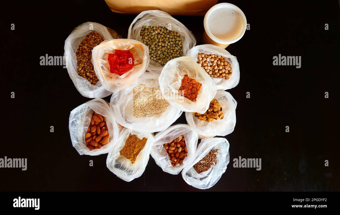 A variety of foodstuffs in open paper bags, including spices and ...