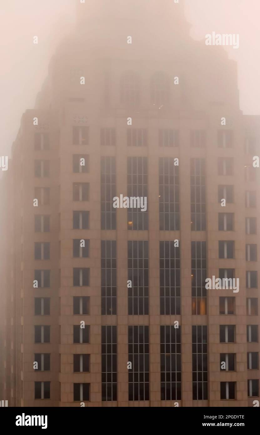 The top of the Ritz-Carlton hotel, covered in fog, located in downtown ...