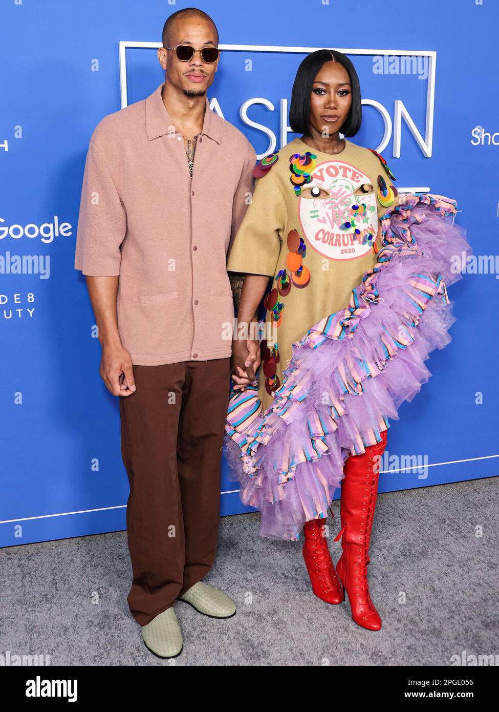 HOLLYWOOD, LOS ANGELES, CALIFORNIA, USA - MARCH 21: Masimba Chibanda and Muni Long arrive at the ...