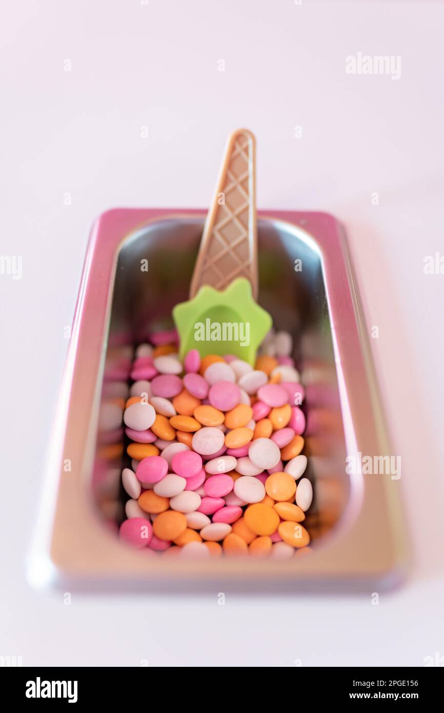 Close up photo of a metal tray filled with chocolate toppings on an ice ...