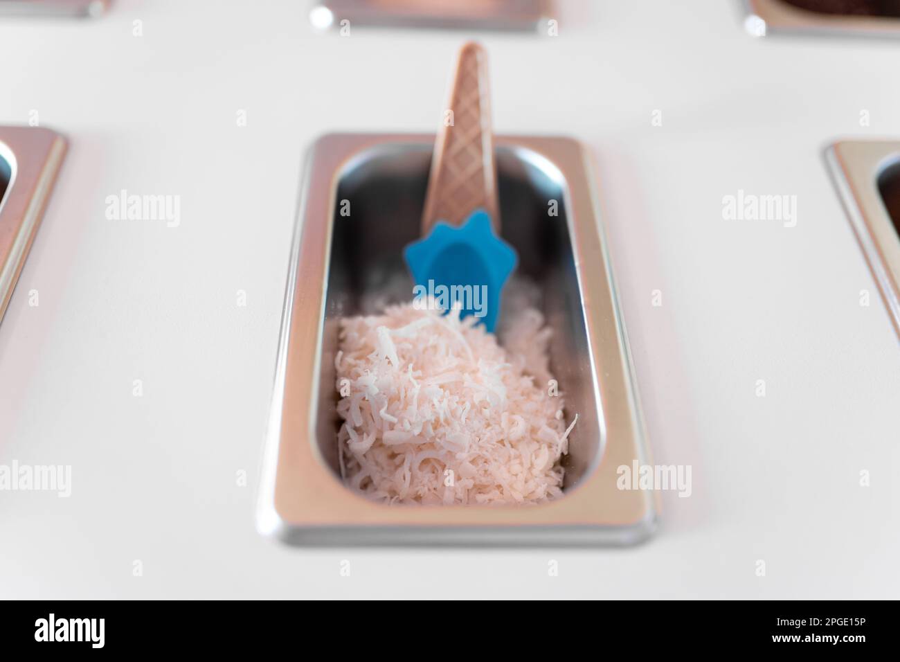 Close up photo of a metal tray filled with striped coconut toppings on ...