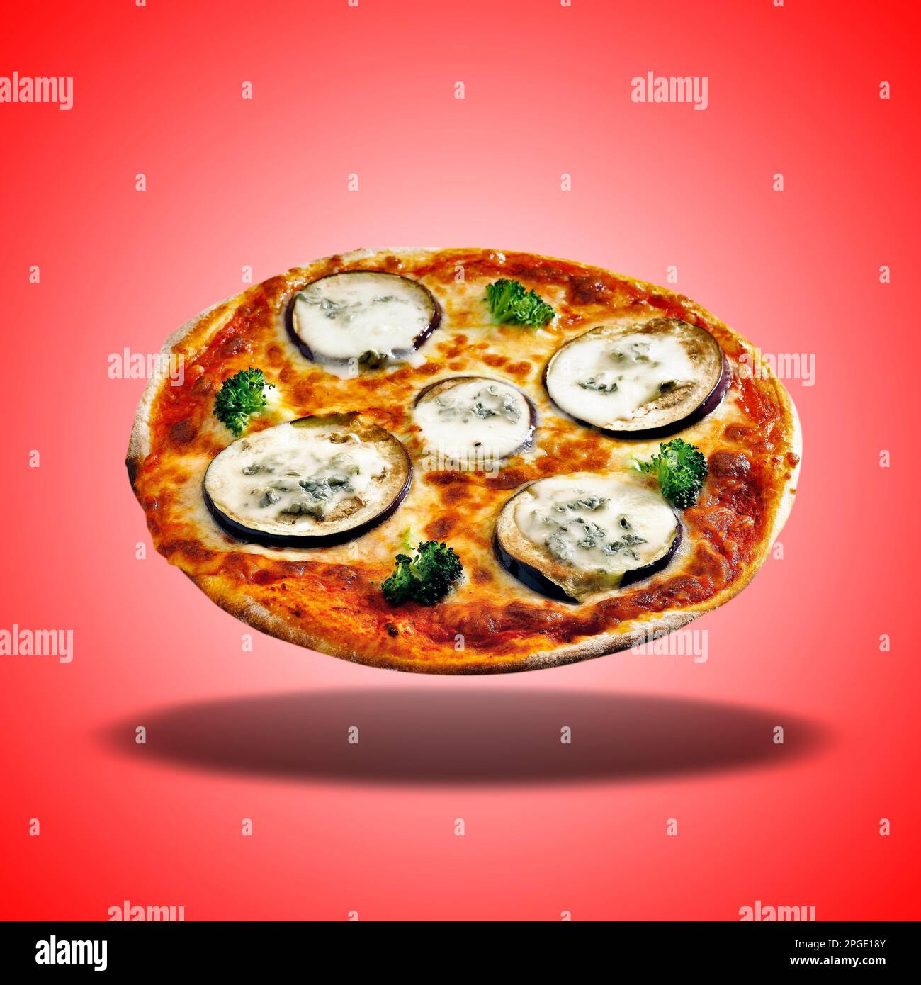 Floating Pizza eggplant on red radial gradient background Stock Photo ...
