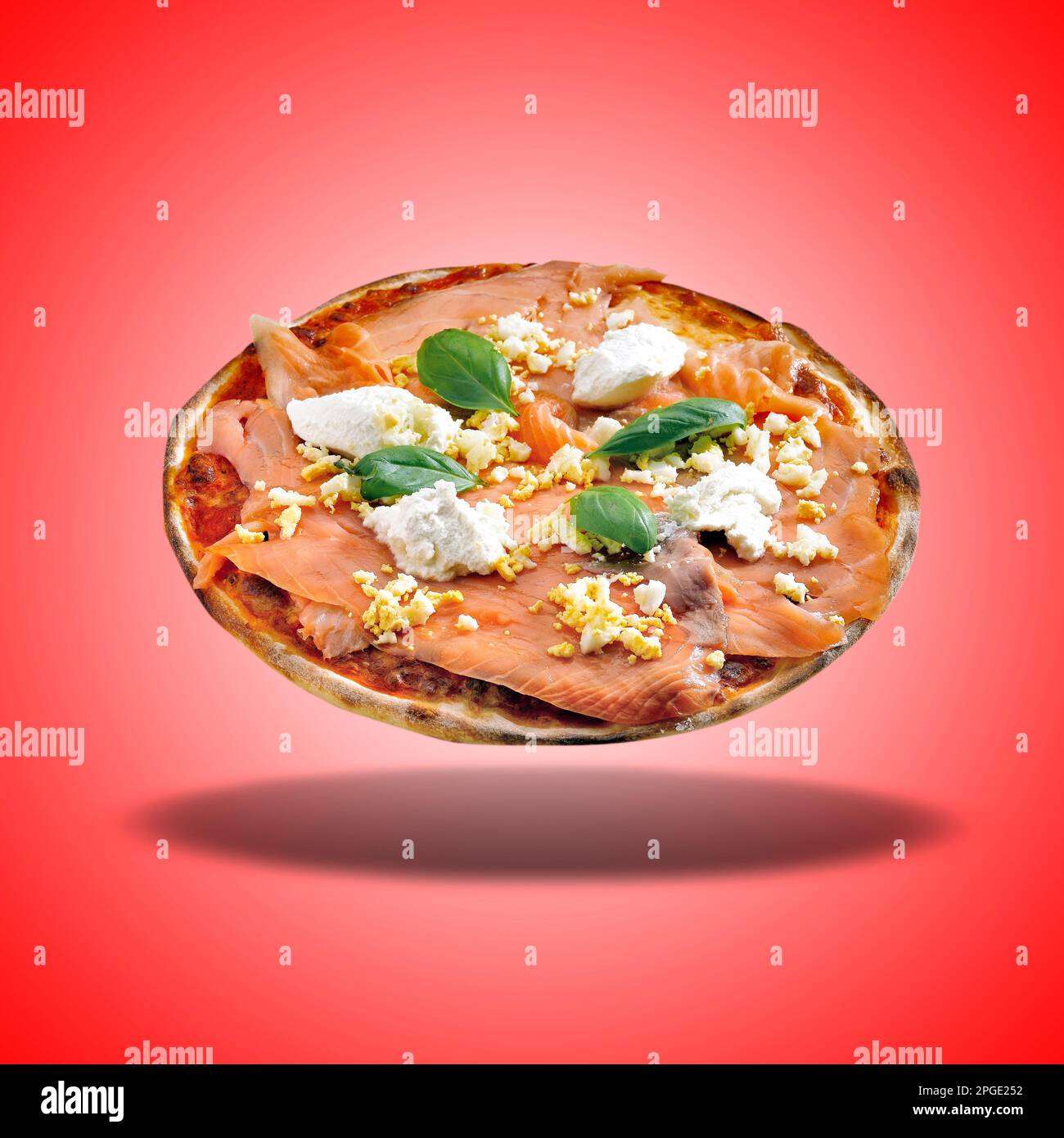 Floating Pizza salmon on red radial gradient background Stock Photo - Alamy