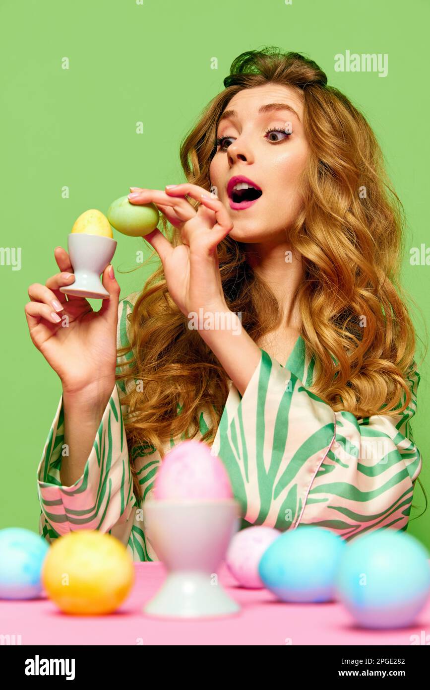 Portrait of young charming girl with long hair holding easter eggs and ...