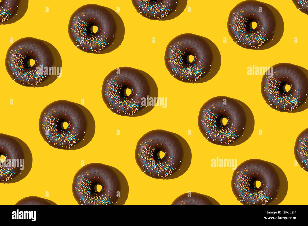 Chocolate donuts pattern isolated on yellow background. Bakery ...