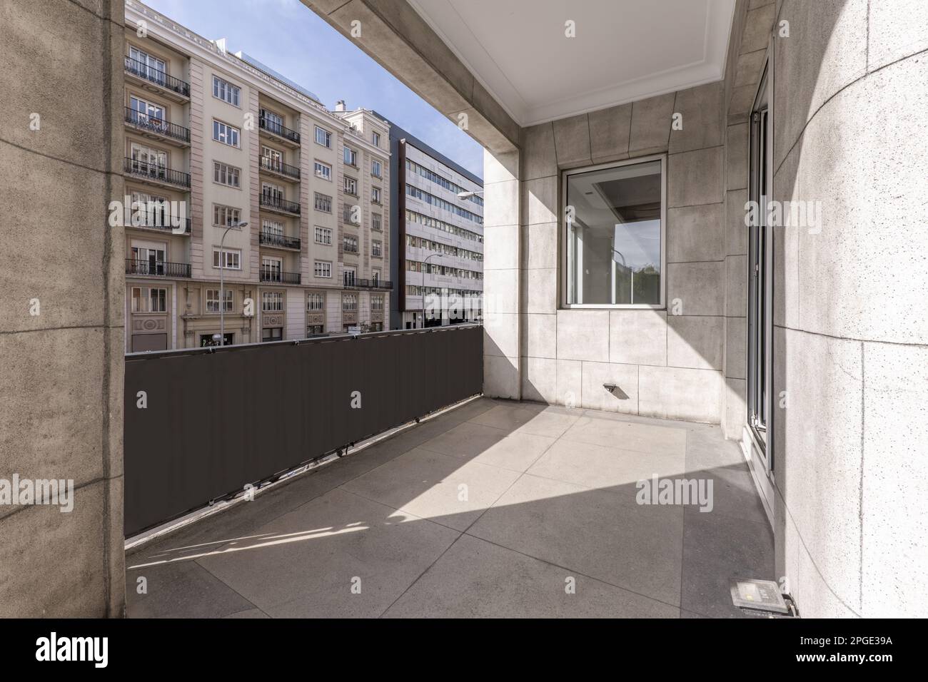 Empty terrace with a gray metal railing and concession tiles on facades ...