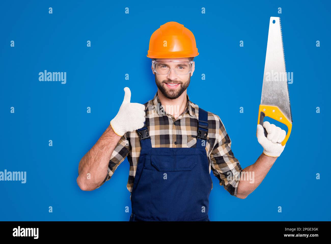 Portrait of handsome joyful master in hard hat, uniform, overall, shirt ...