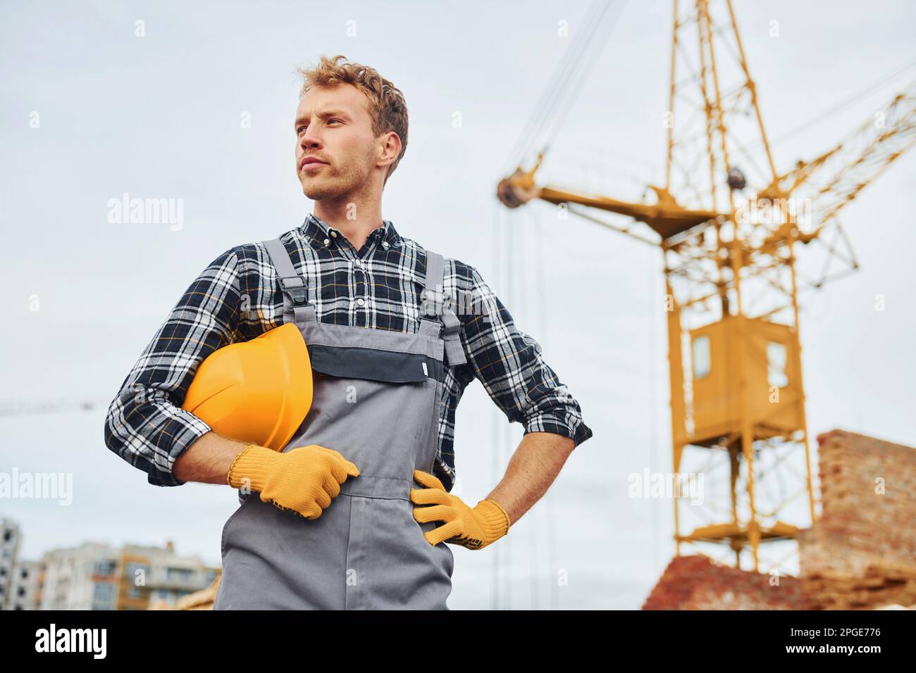 Takes a break. Construction worker in uniform and safety equipment have ...