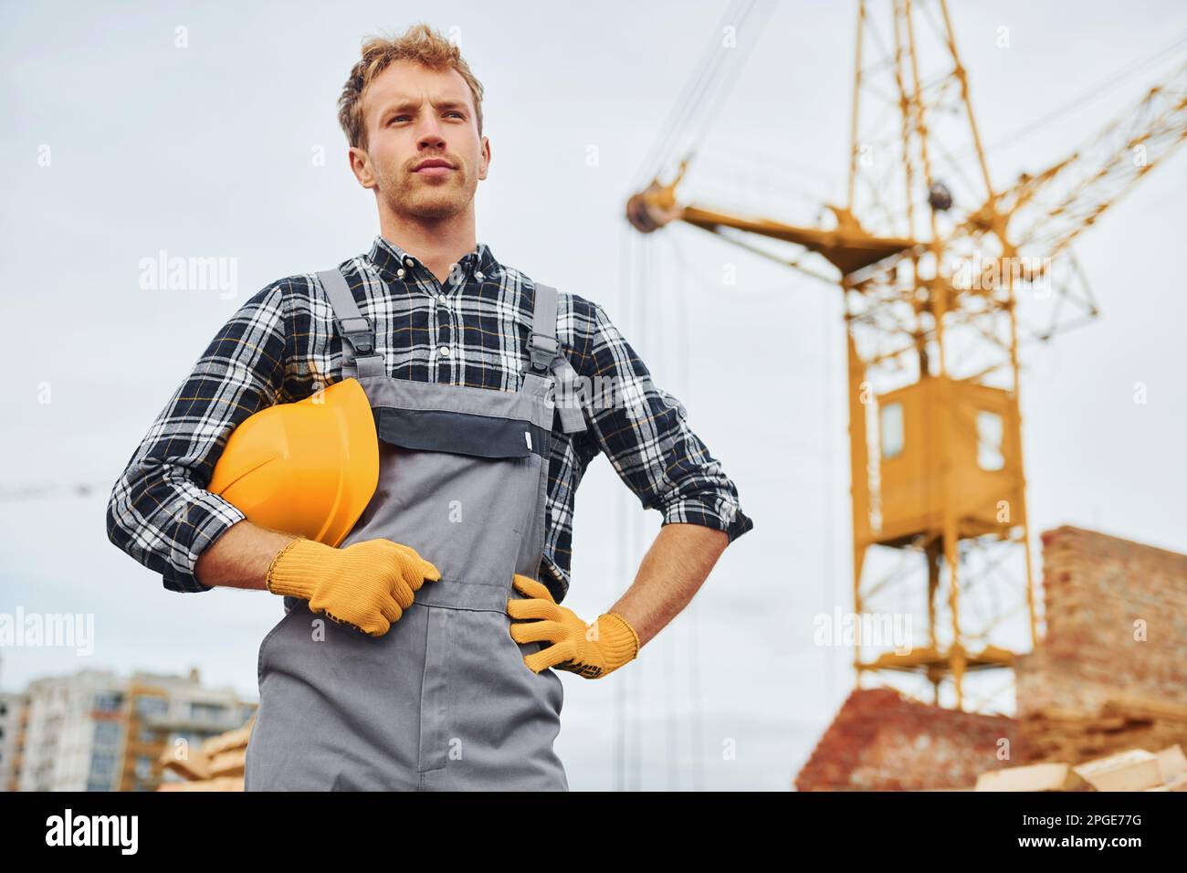 Takes a break. Construction worker in uniform and safety equipment have ...