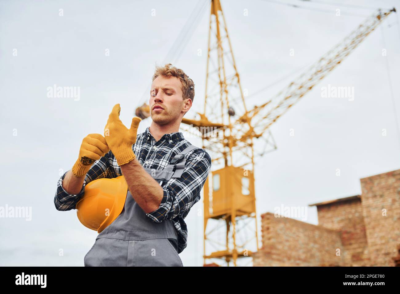 Takes a break. Construction worker in uniform and safety equipment have ...