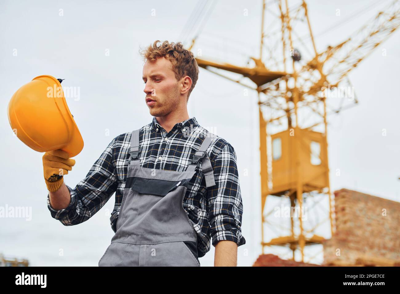 Takes a break. Construction worker in uniform and safety equipment have ...