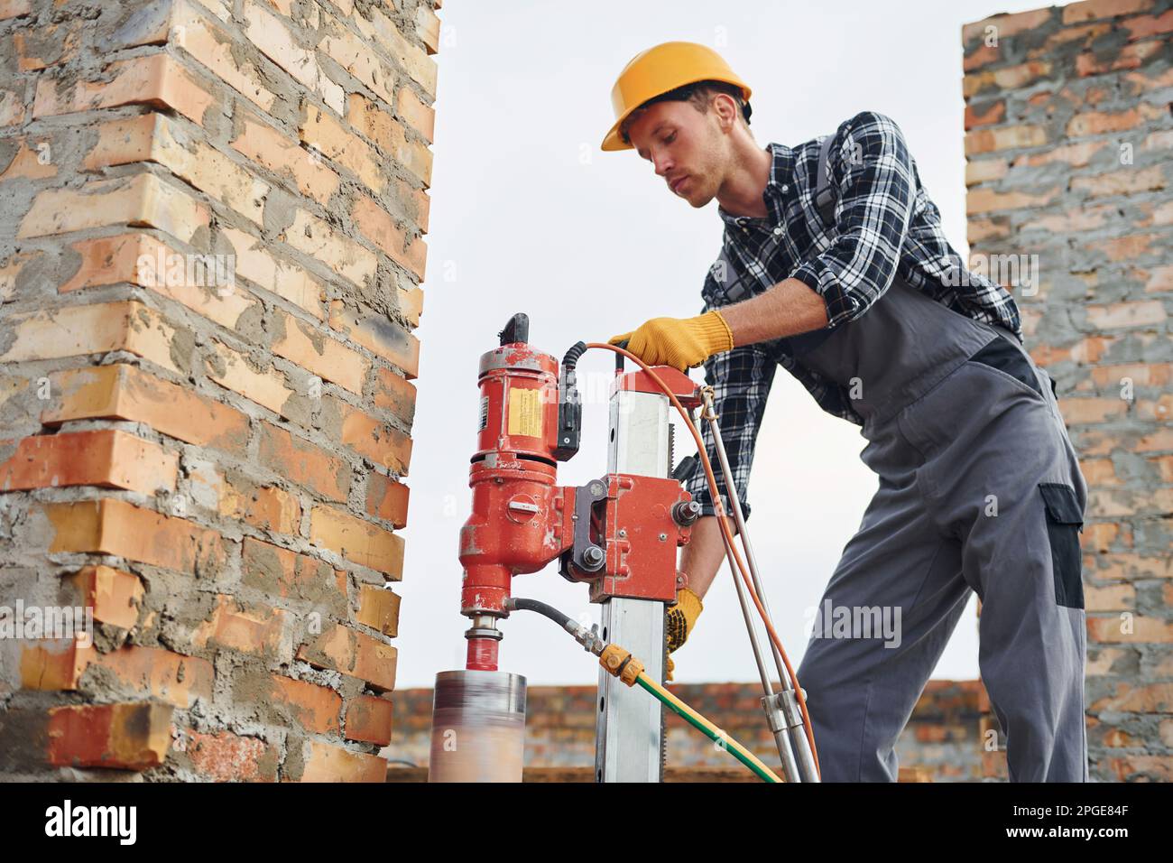 Uses blending drill. Construction worker in uniform and safety ...
