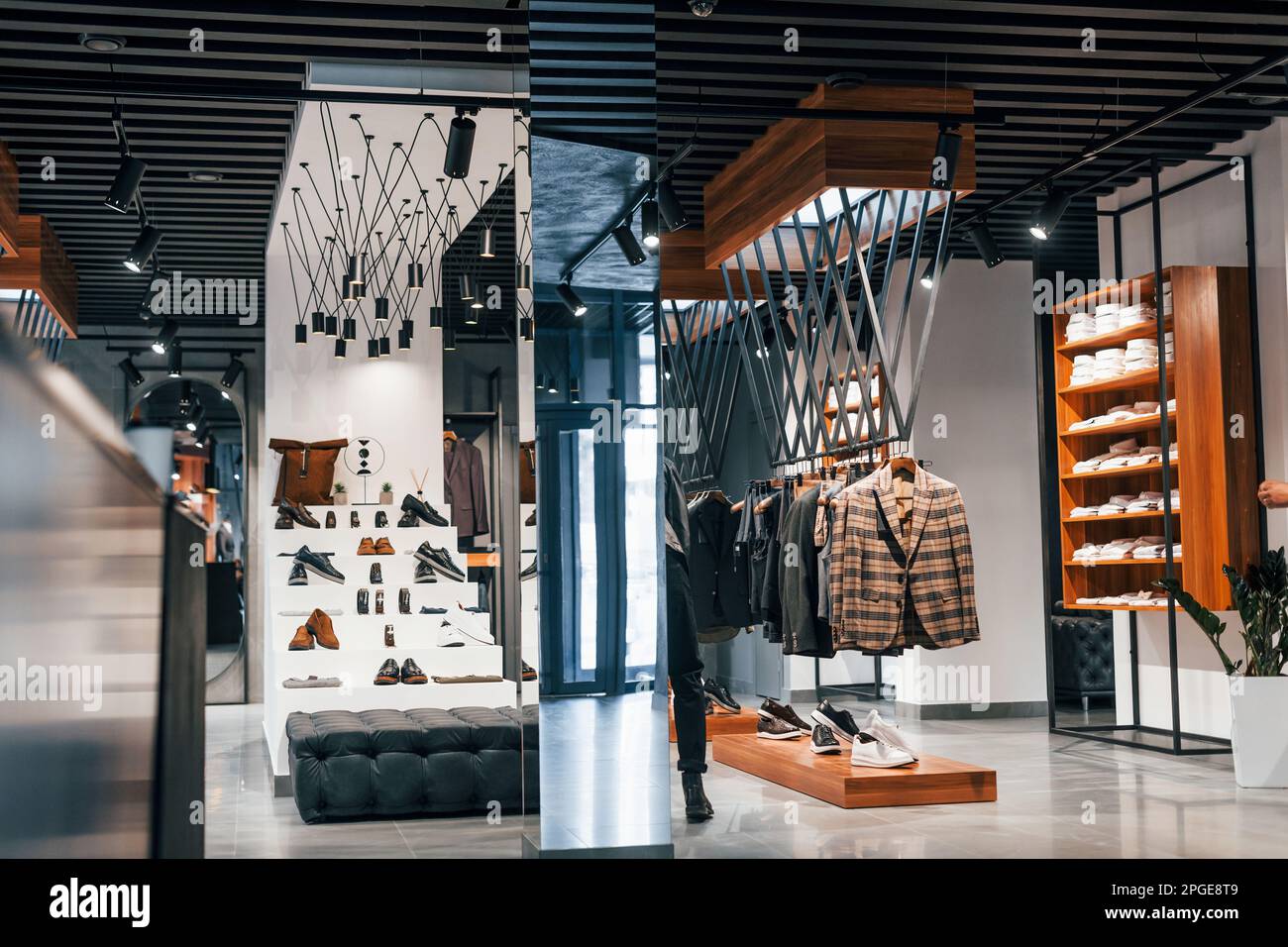 Stylish new clothes in modern store. Elegant expensive wear for men ...