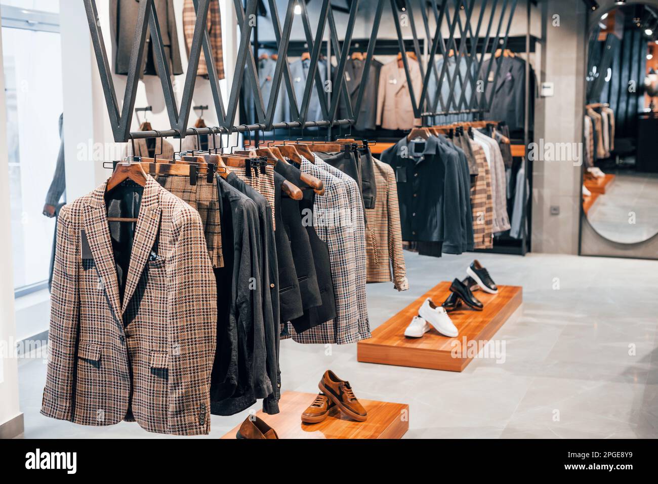 Stylish new clothes in modern store. Elegant expensive wear for men ...