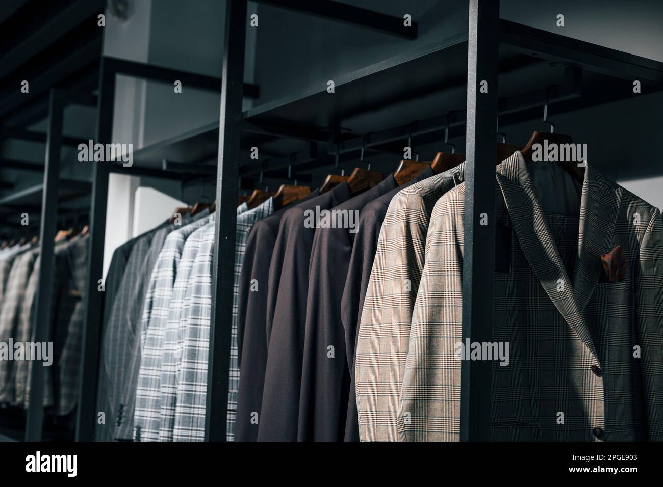 Stylish new clothes in modern store. Elegant expensive wear for men ...