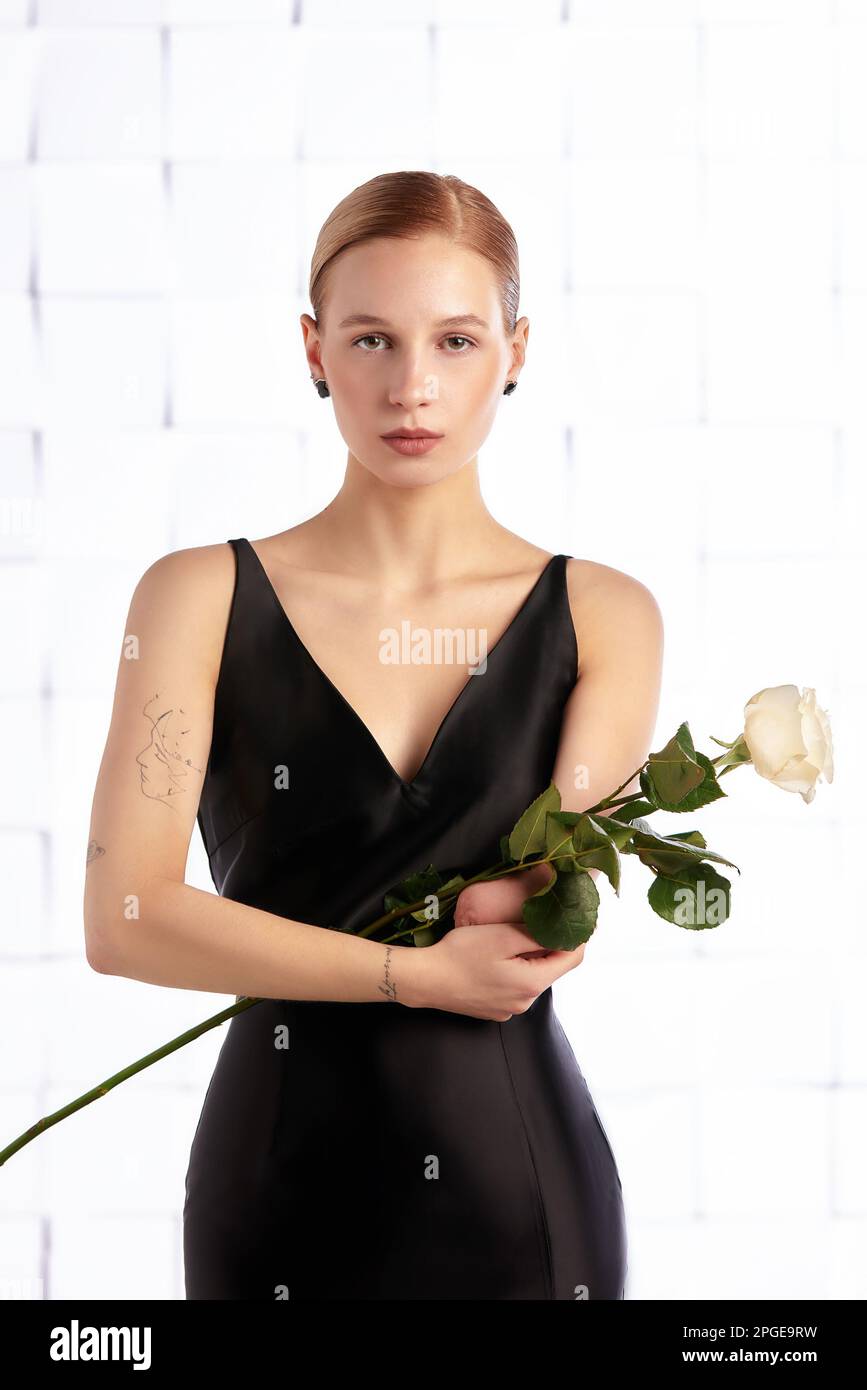 Beautiful young with special needs woman with flowers in her hand ...