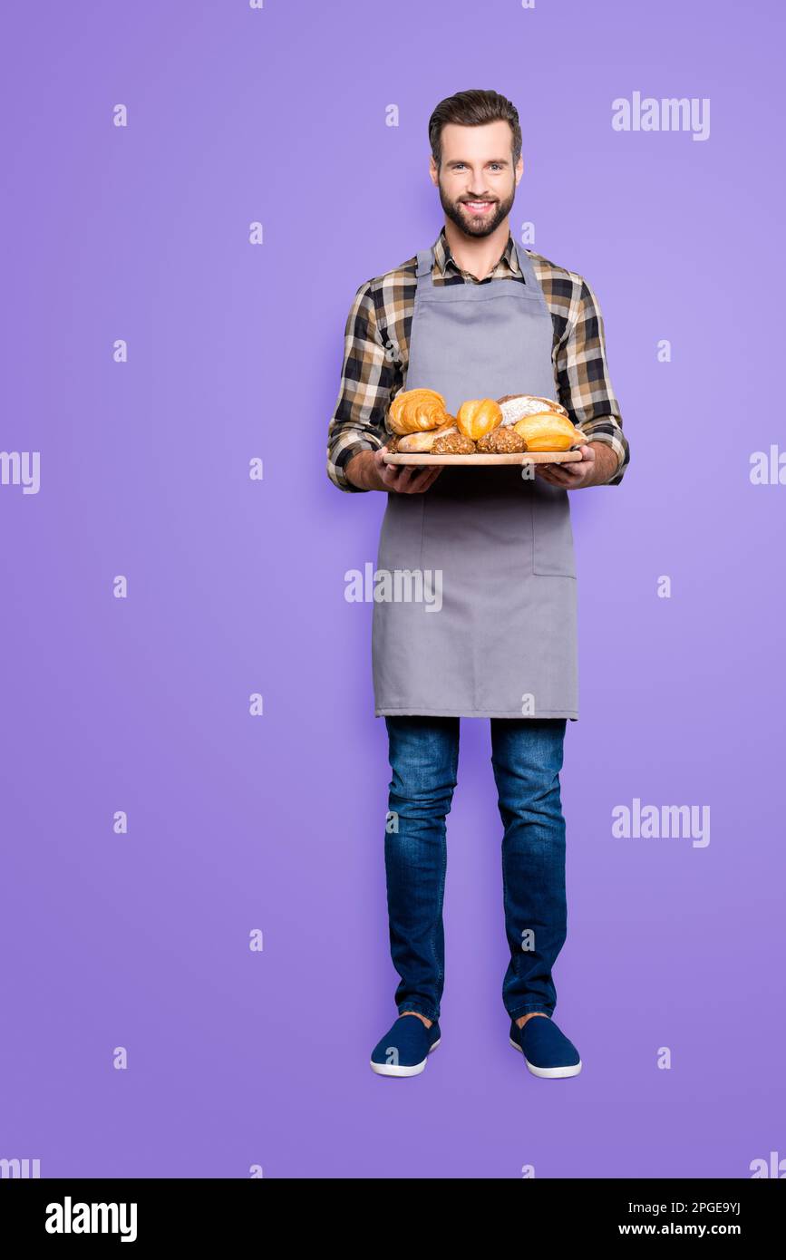 Full size body portrait of joyful cheerful baker in jeans, shoes, shirt ...