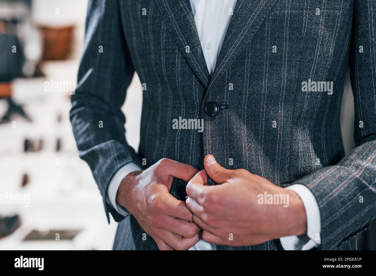Close up view. Young guy in modern store with new clothes. Elegant ...