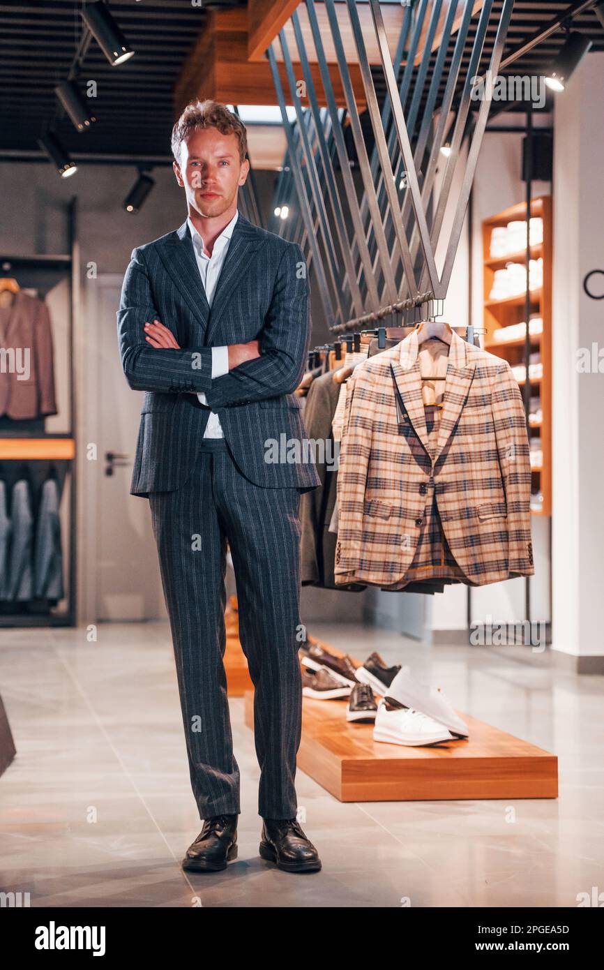 Shopping day. Young guy in modern store with new clothes. Elegant ...