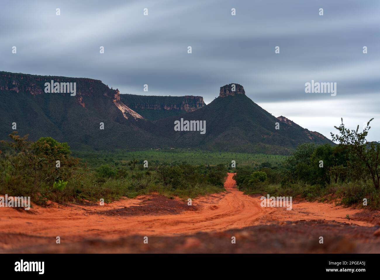 Red Dirt Road Leading to Green Pyramid Mountain in Stormy Skies Stock ...