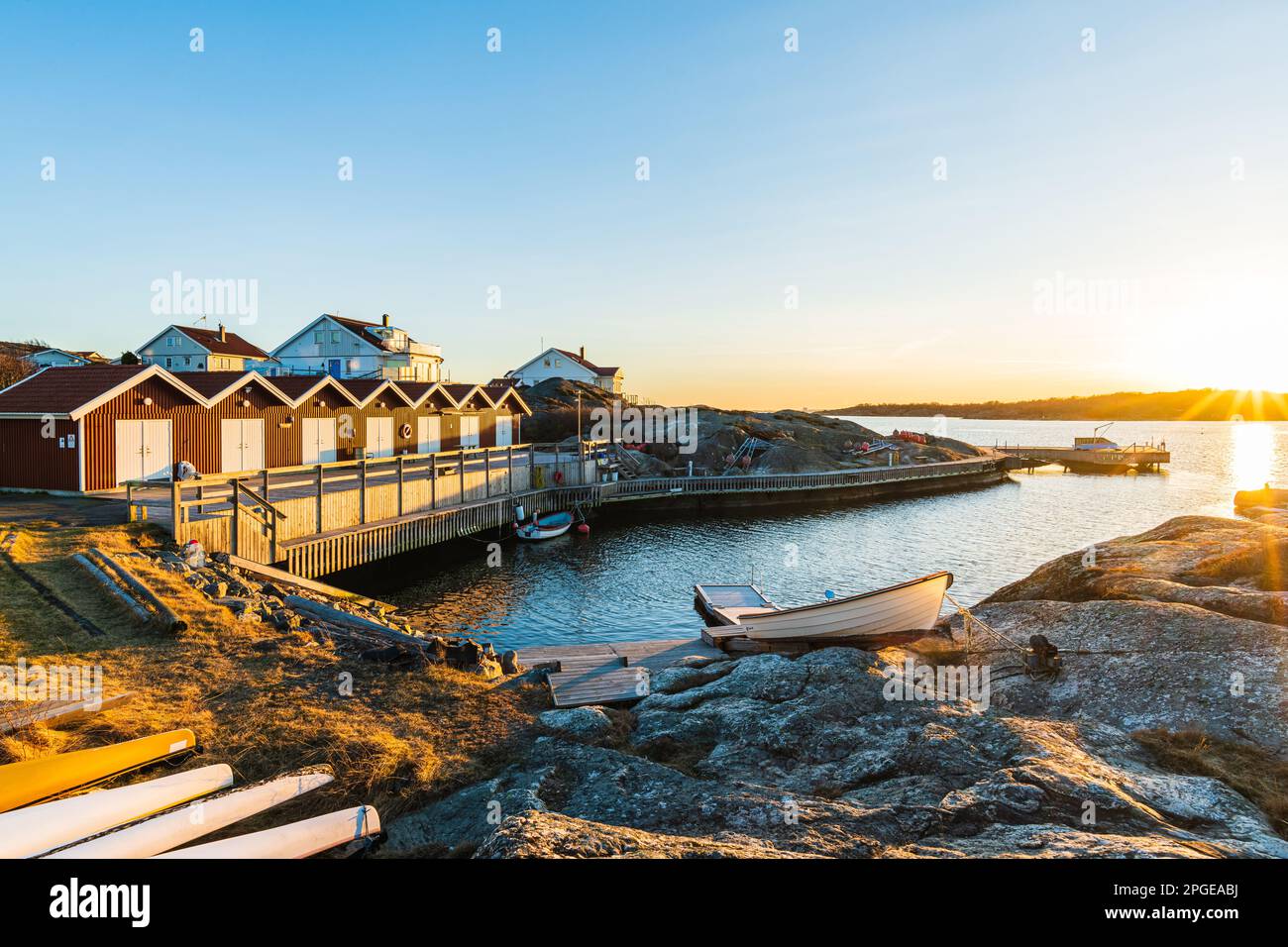 The picture displays a beautiful sunset over the harbor of an old ...