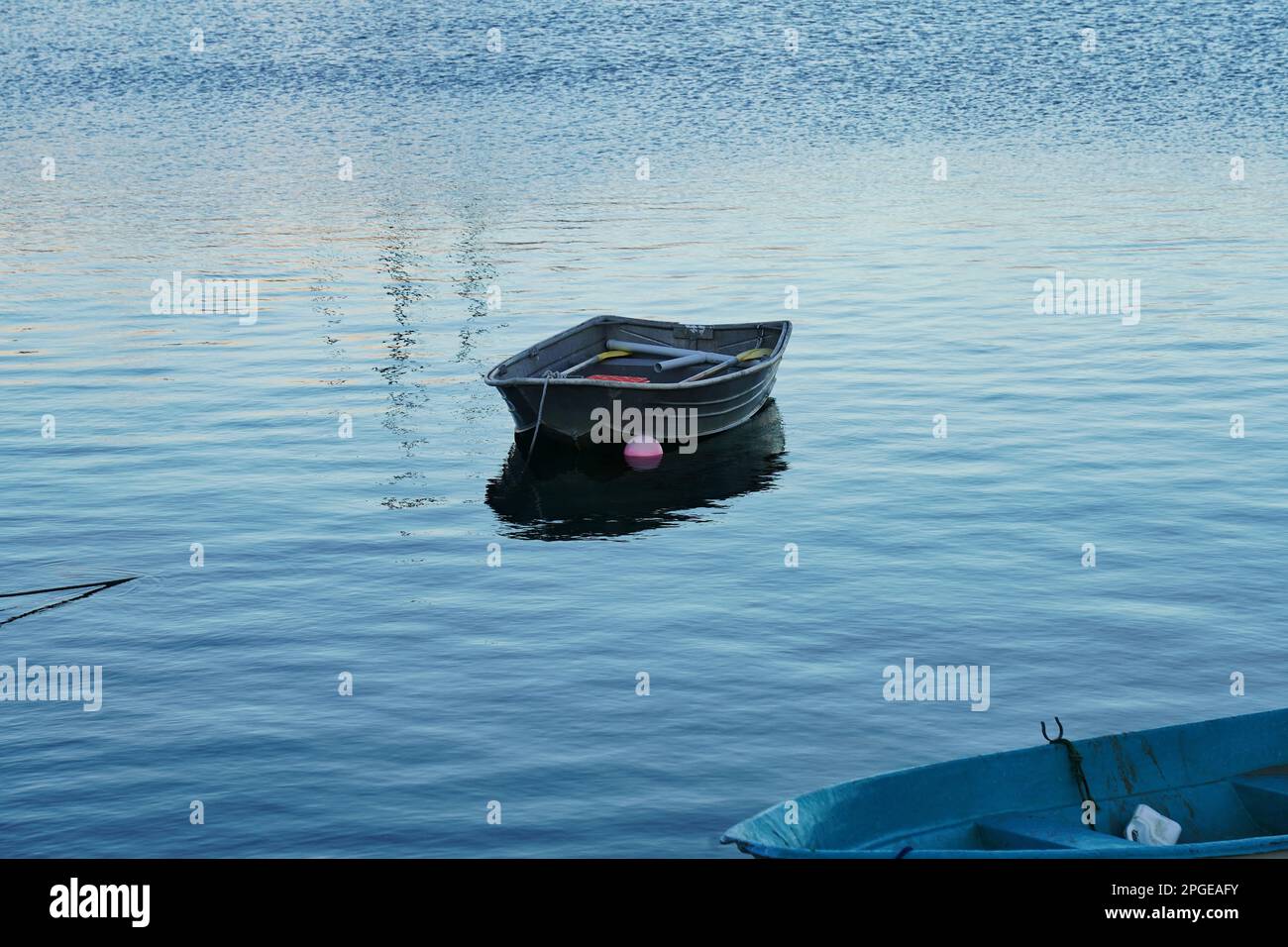 Two boats moored alongside a tranquil body of water Stock Photo - Alamy