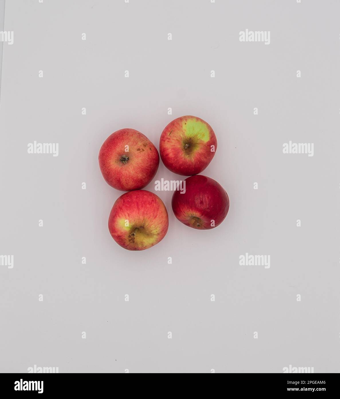 Top of view of four small red apples on white background Stock Photo ...