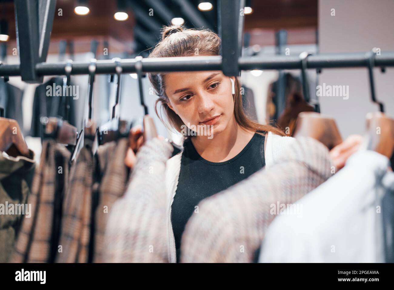 Girl is in modern store with new clothes. Elegant expensive wear Stock ...
