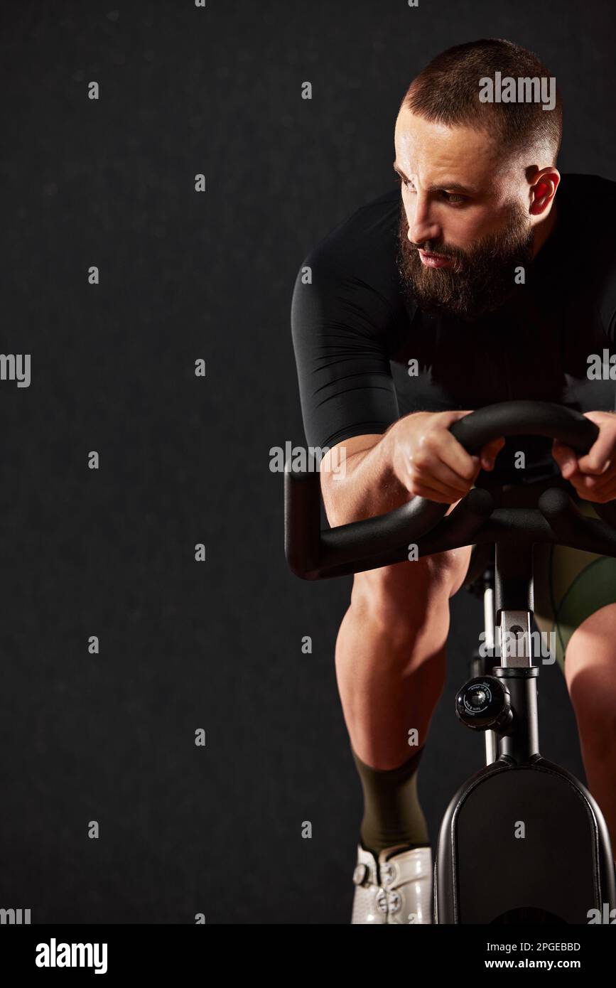 Close-up portrait of a cyclist on a dark background floor of the face ...