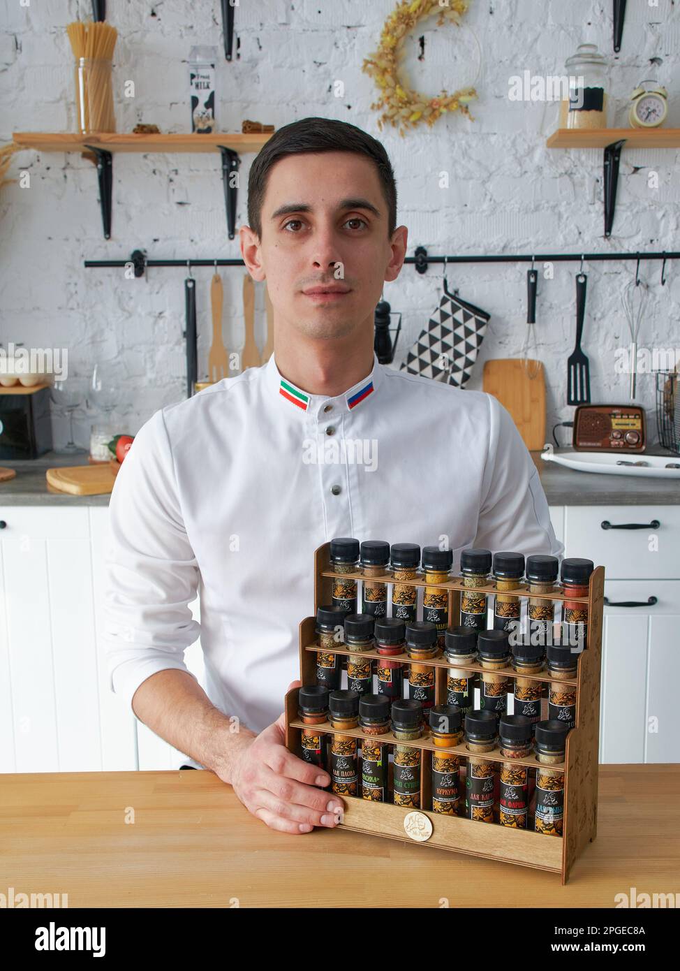 Restaurant chef and a set of jars with different spices in a wooden box ...