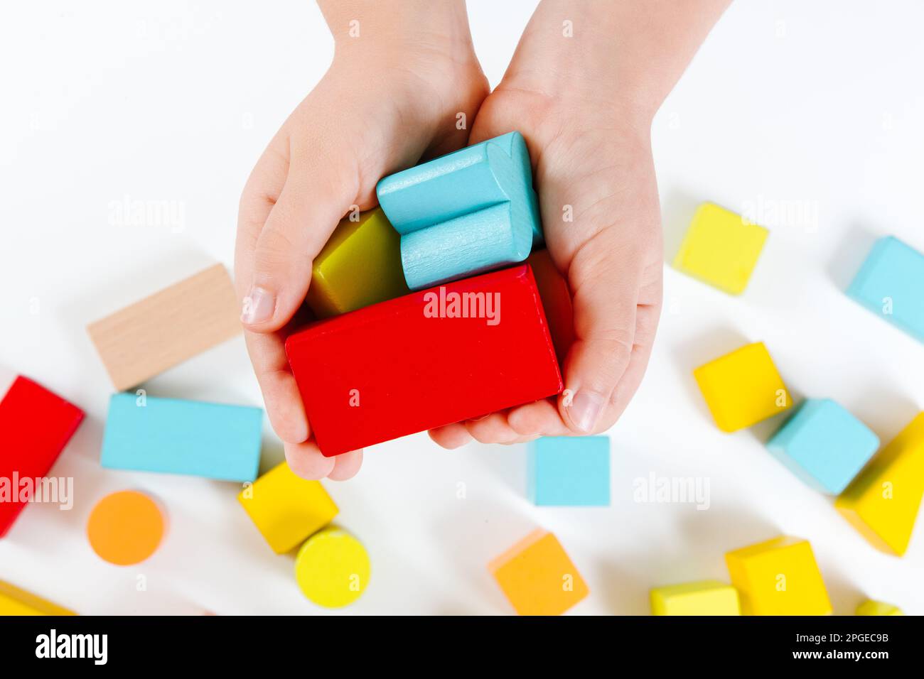 Child's hands playing with colorful wooden bricks. Wooden play set ...