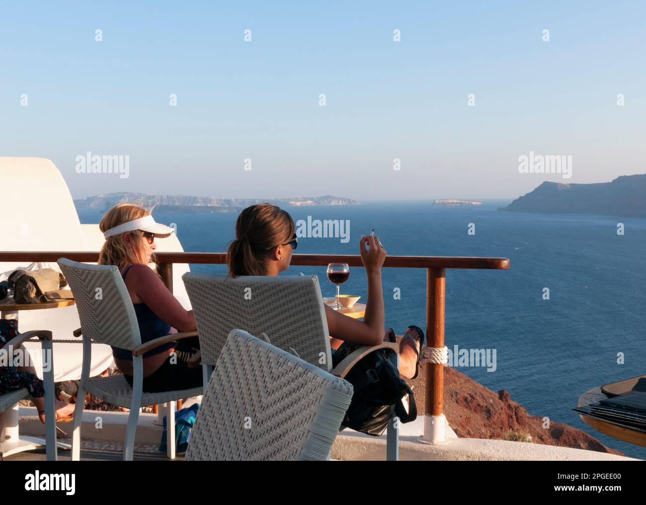 Rooftop bar overlooking the Mediterranean in Oia. Close friends ...