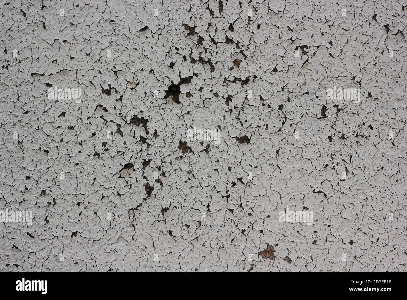 A full frame view of an old worn and weathered painted wall with lots ...