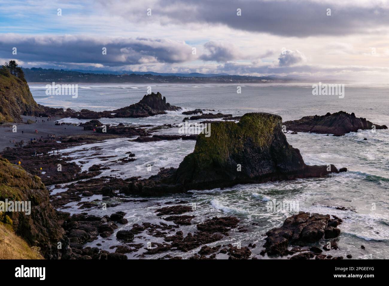 The cloudy sunset sky over the sea captured from the rocky coast in ...