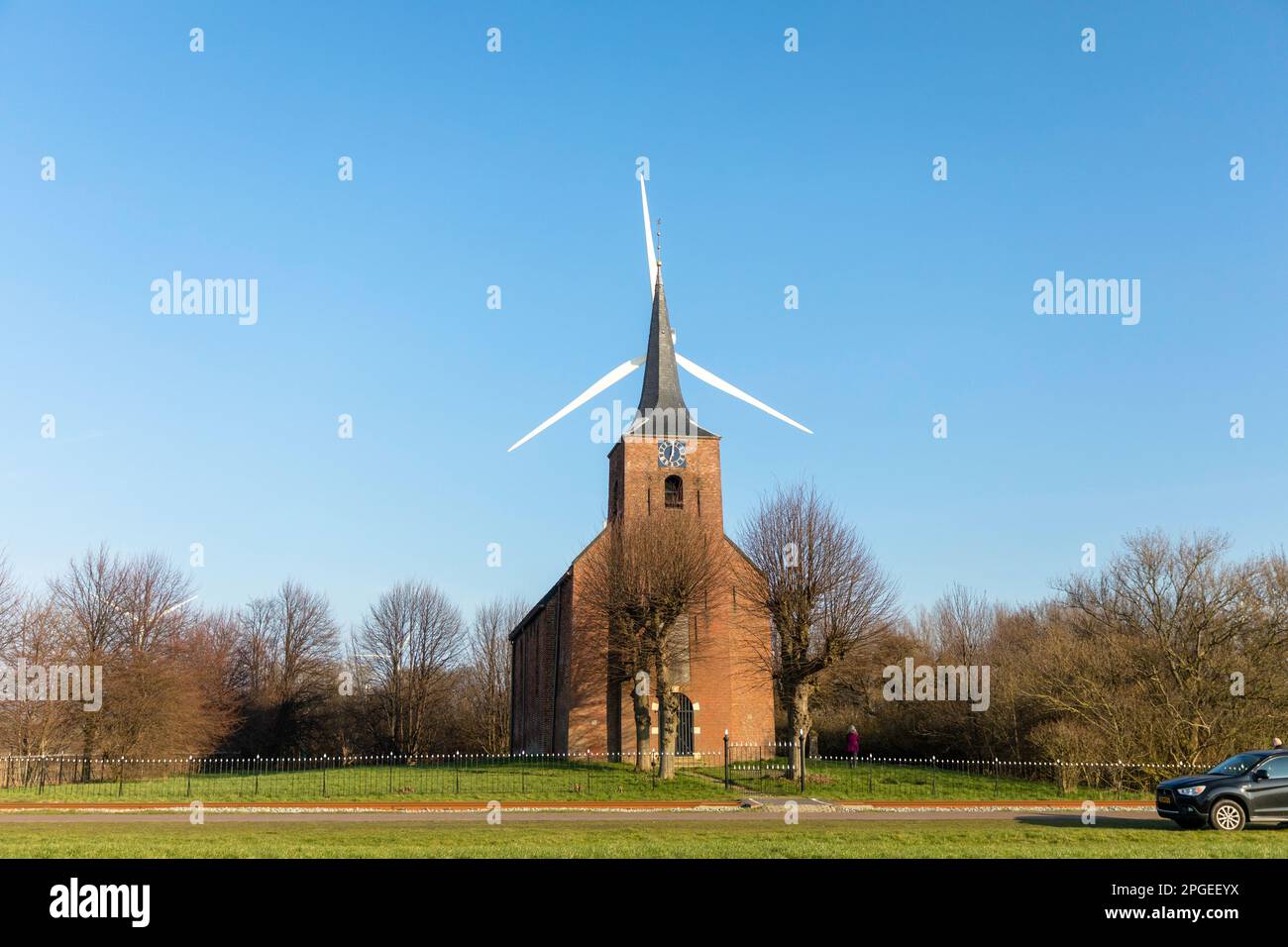 A modern wind turbine is seen behind a 16th century church, all that's ...