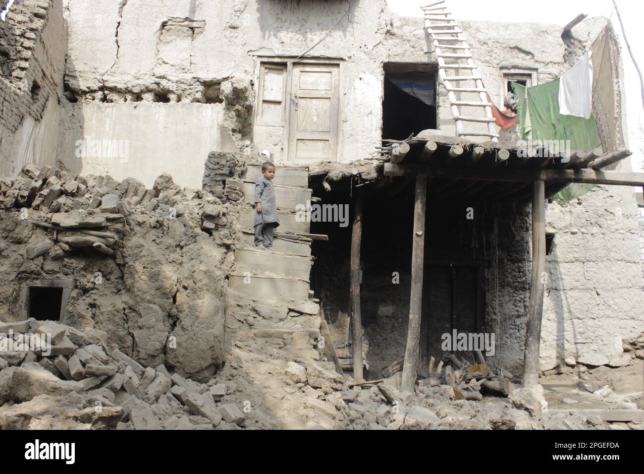 Laghman, Afghanistan. 22nd Mar, 2023. A child stands on the rubble of ...