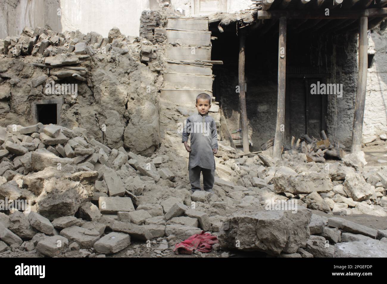 Laghman, Afghanistan. 22nd Mar, 2023. A child stands on the rubble of ...