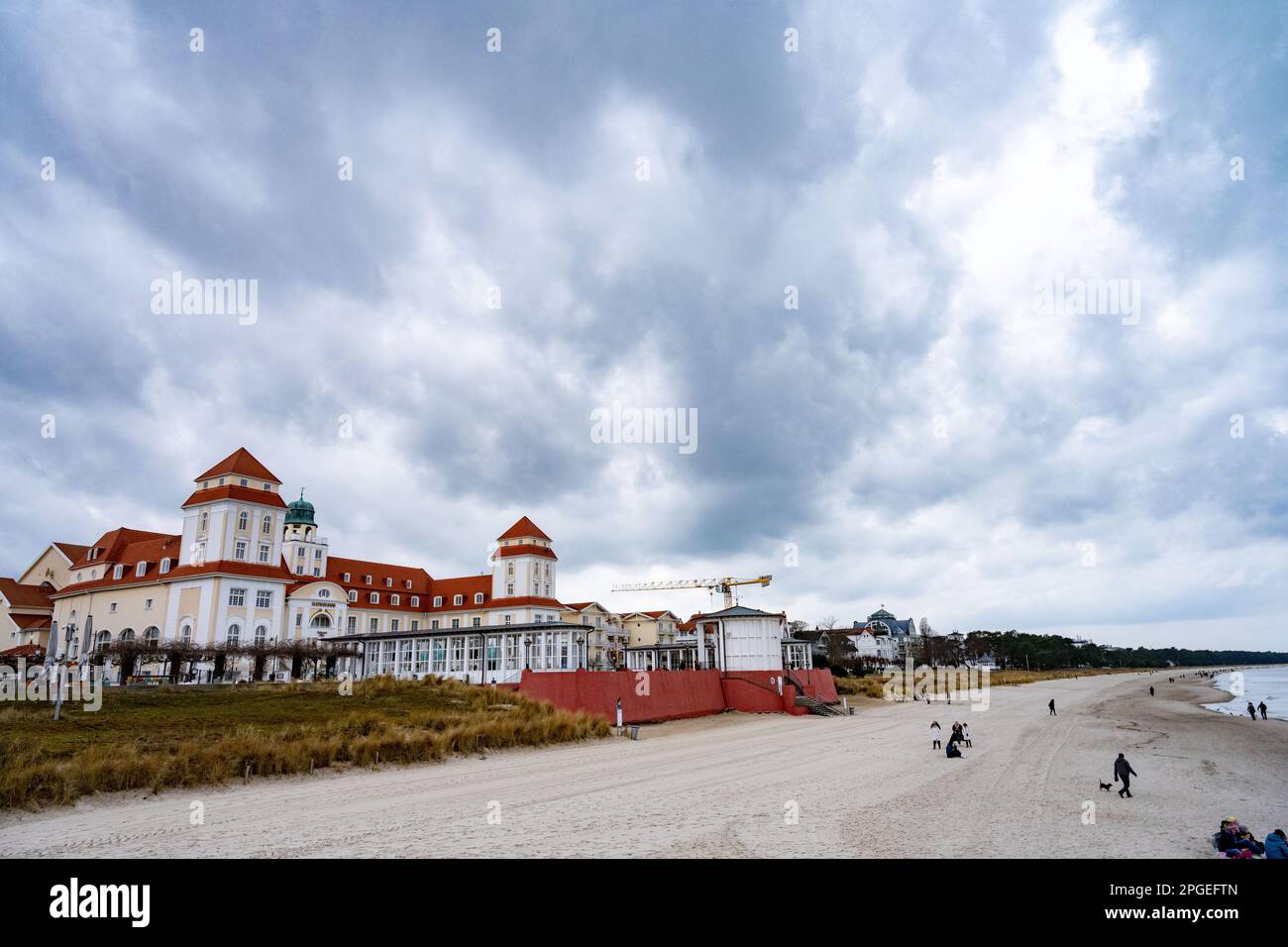 Binz, Germany. 22nd Mar, 2023. Tourists walk on the beach in front of ...